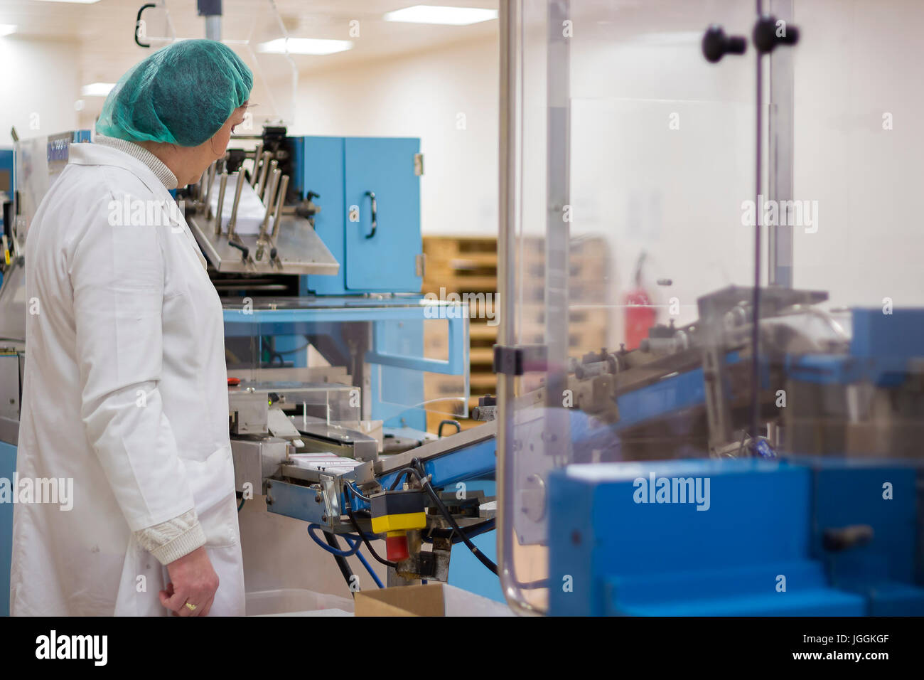 Pharmaceutical female worker controlling the medical pill packaging ...