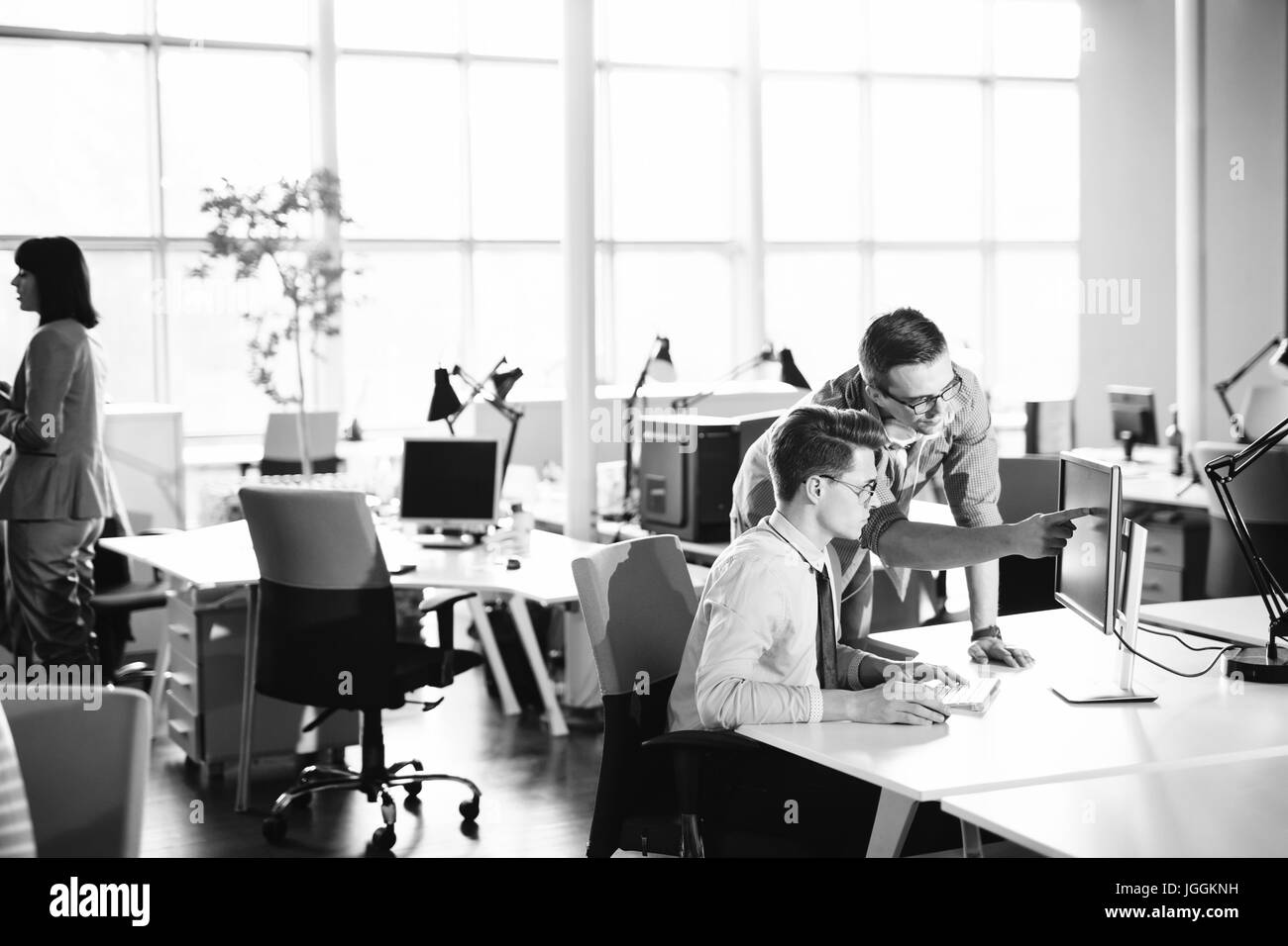 two business people using computer preparing for next meeting and ...
