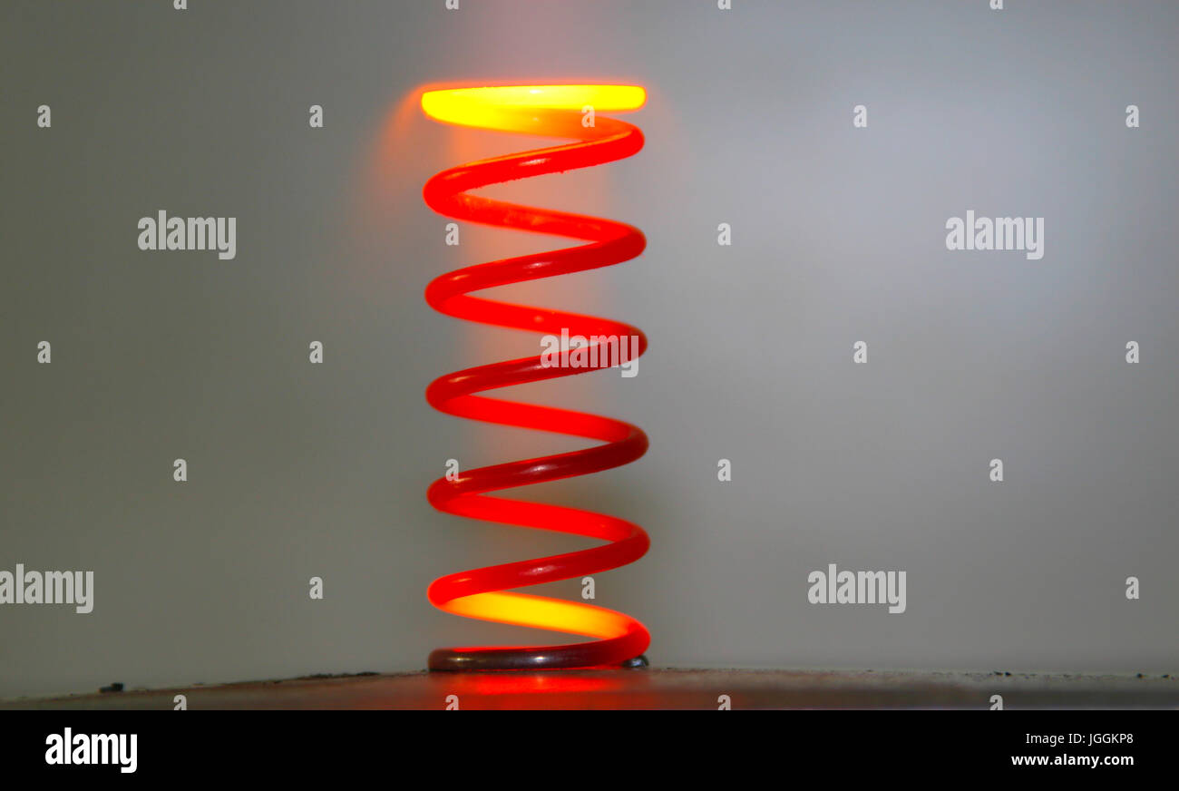 Red hot glowing steel spring Stock Photo - Alamy