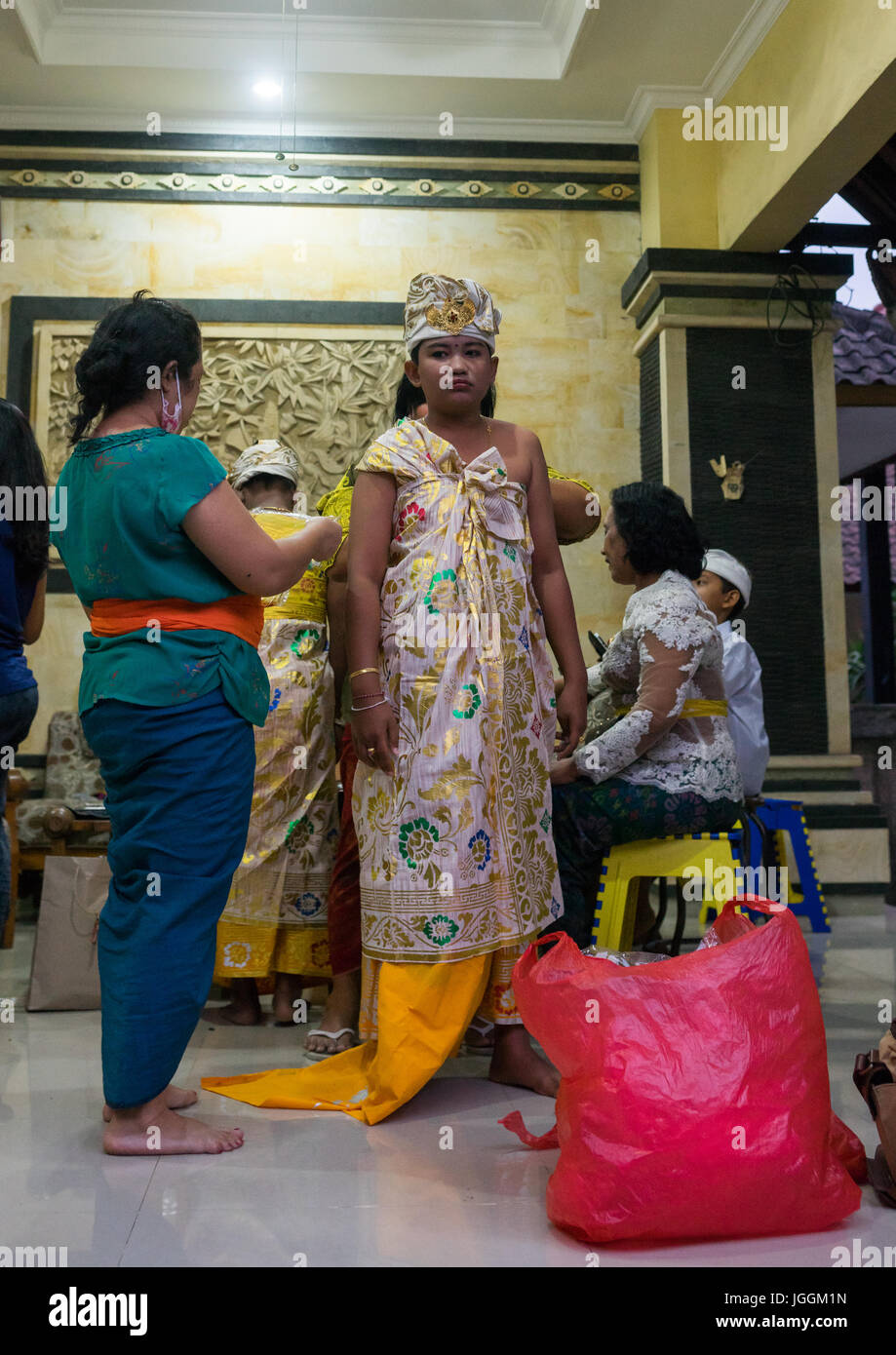 A teenage boy dressed in traditional costume before a tooth filing ...