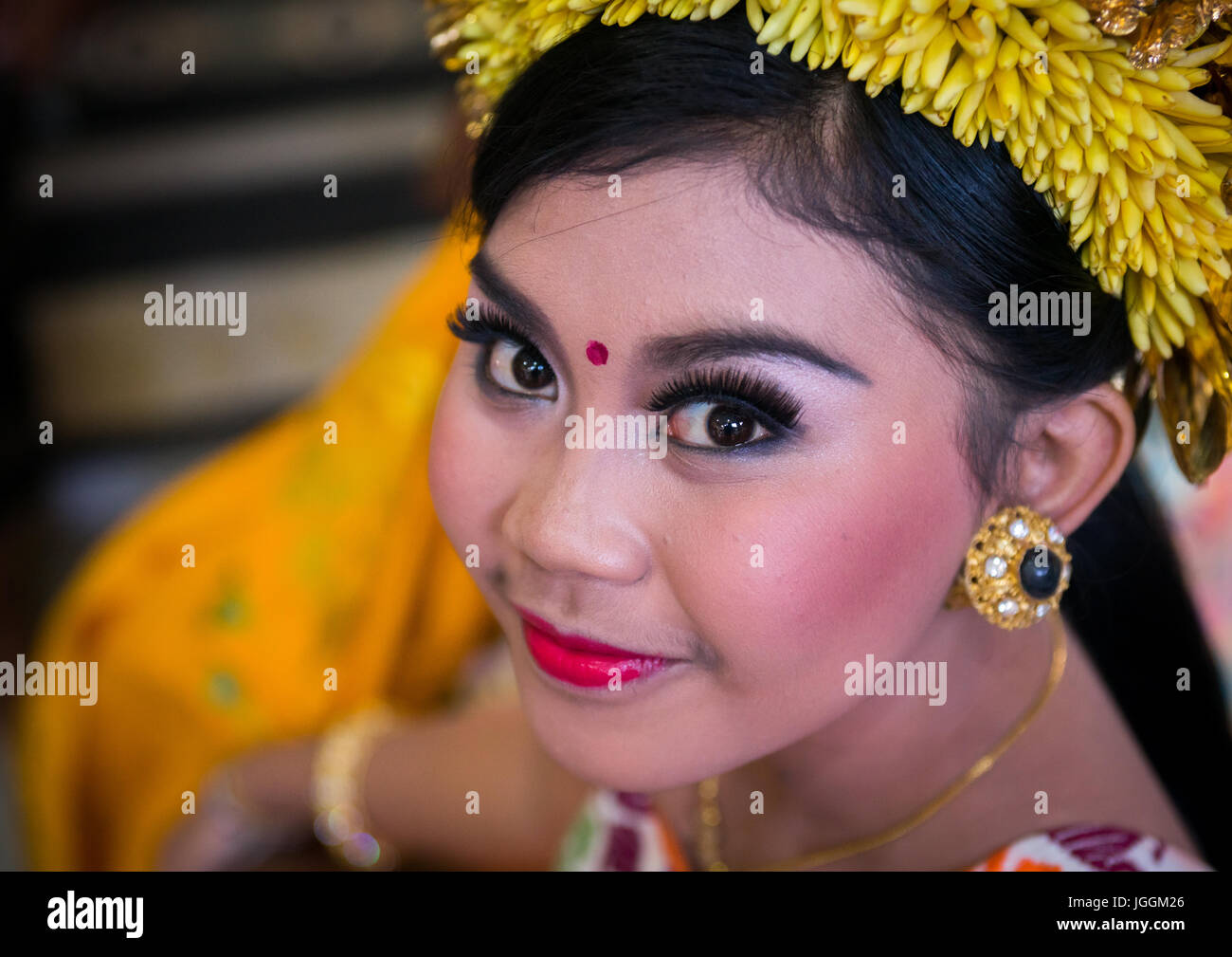 A teenage girl in traditional costume before a tooth filing ceremony ...