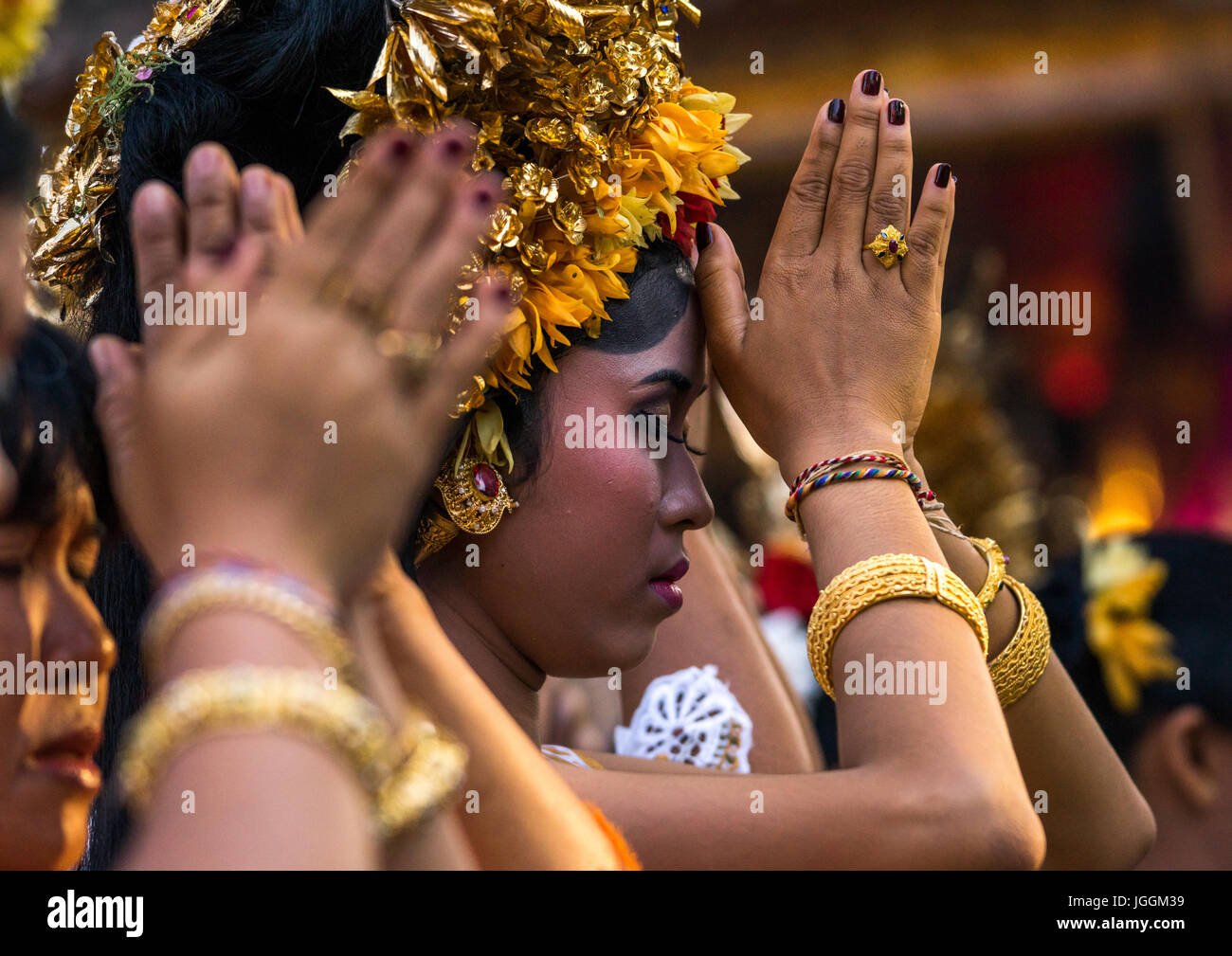 Teenage girls in traditional costume praying before a tooth filing ...