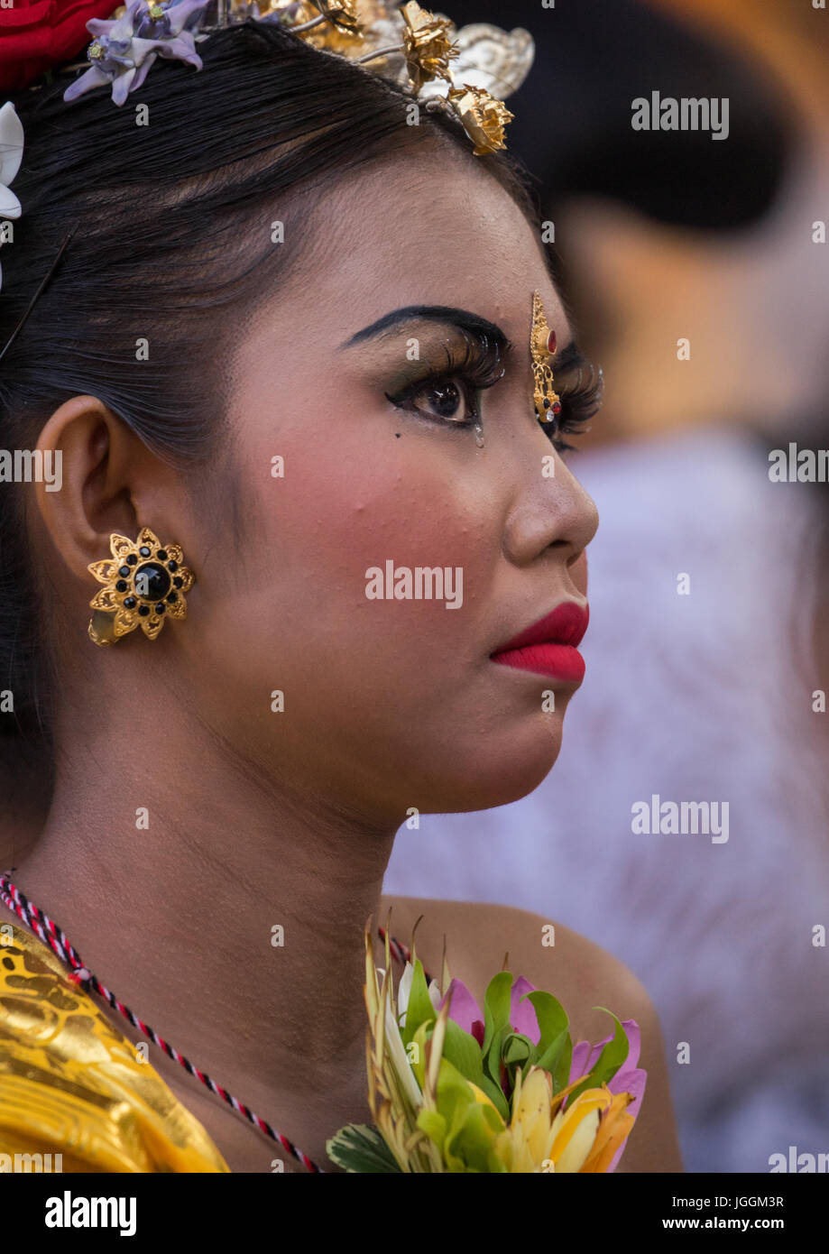 A teenage girl in traditional costume crying before a tooth filing ...