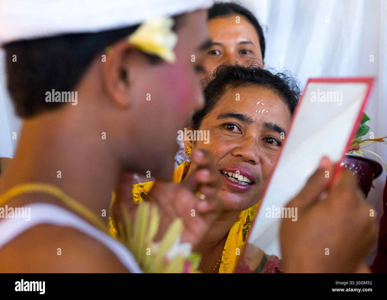 Teenage boy looking at her new teeth in a mirror during the the tooth ...