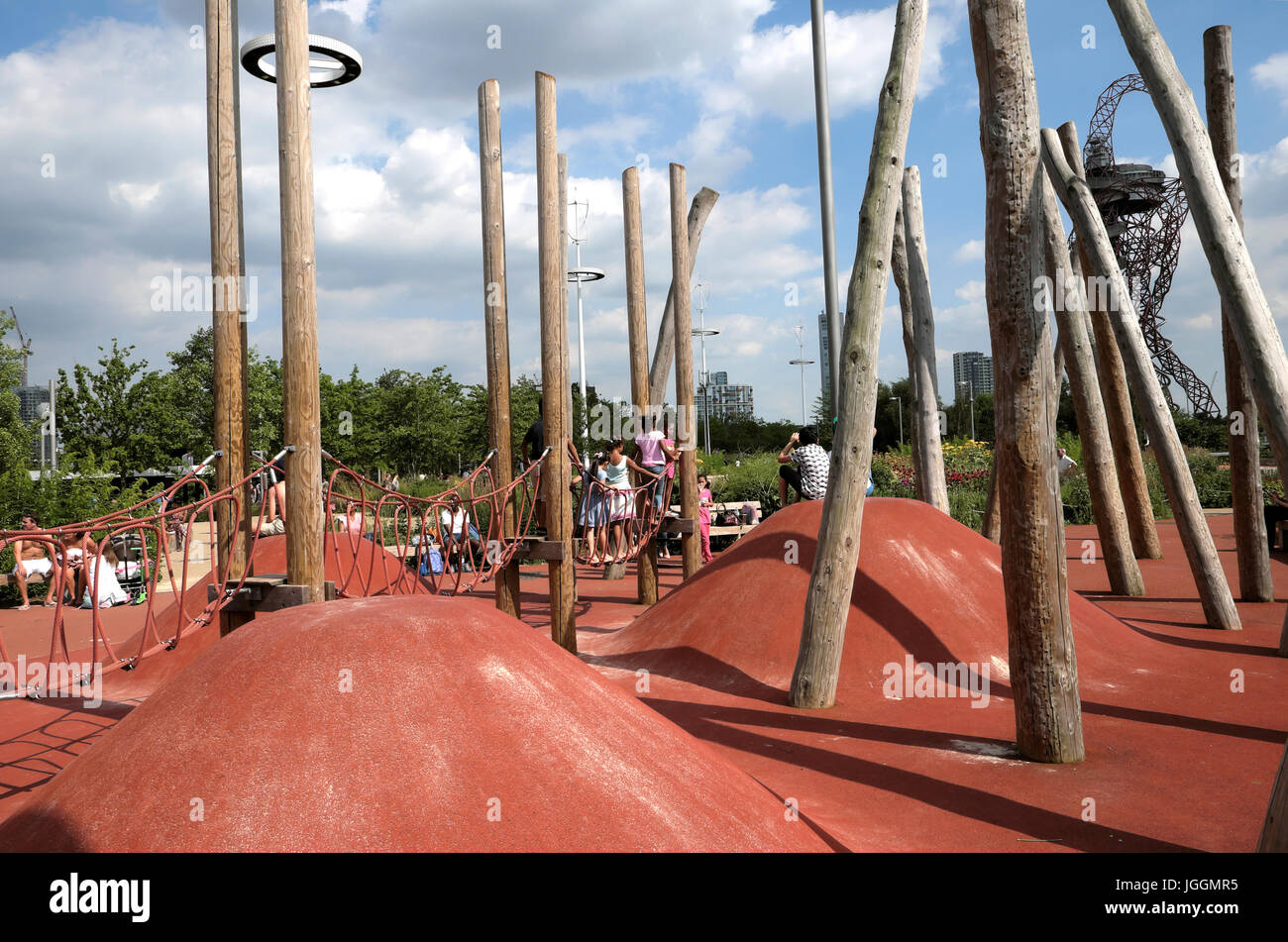 Childrens playground with pole structure & kids playing outside in the ...
