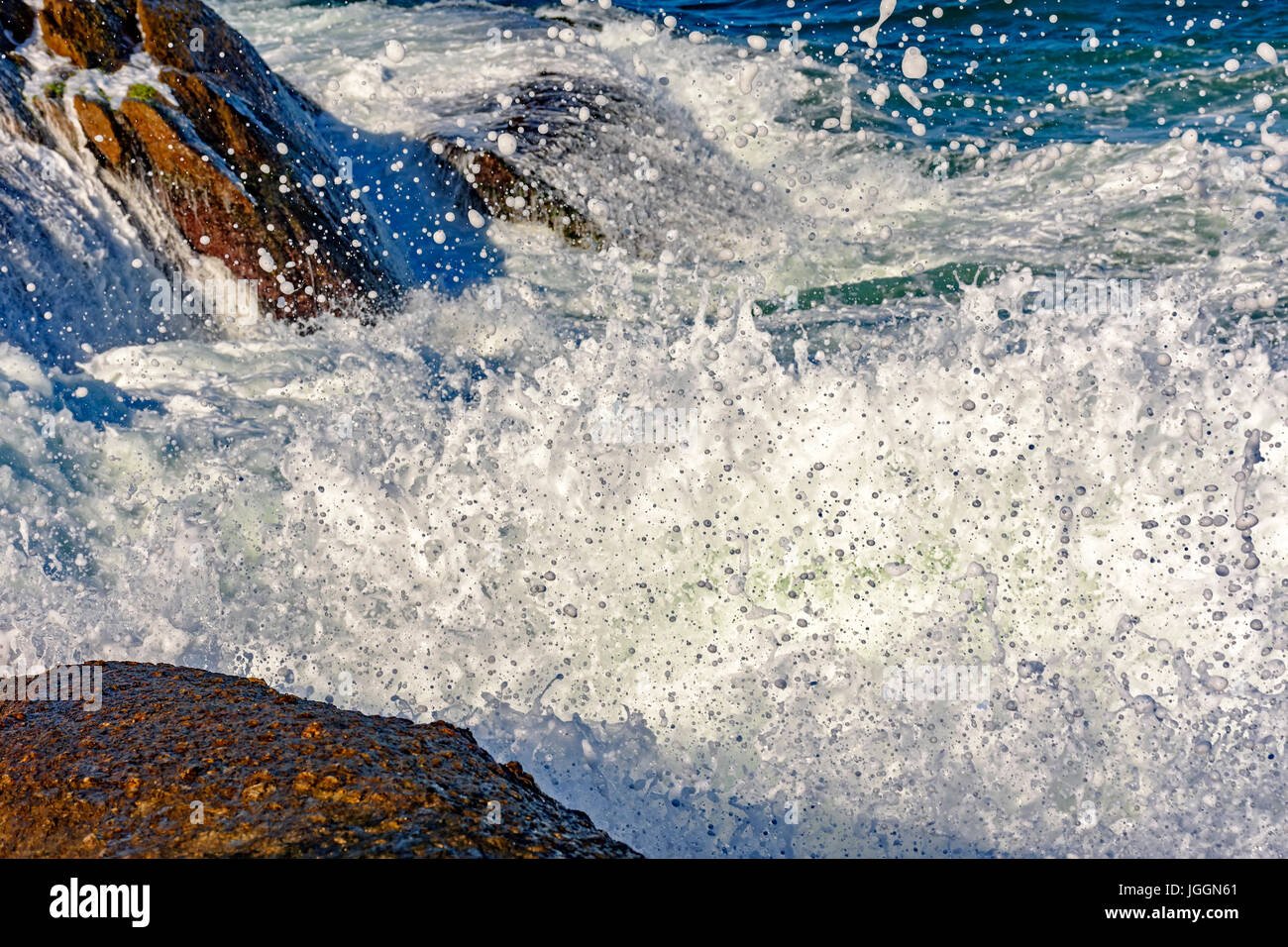 Seawater splashing on seashore rocks hi-res stock photography and ...