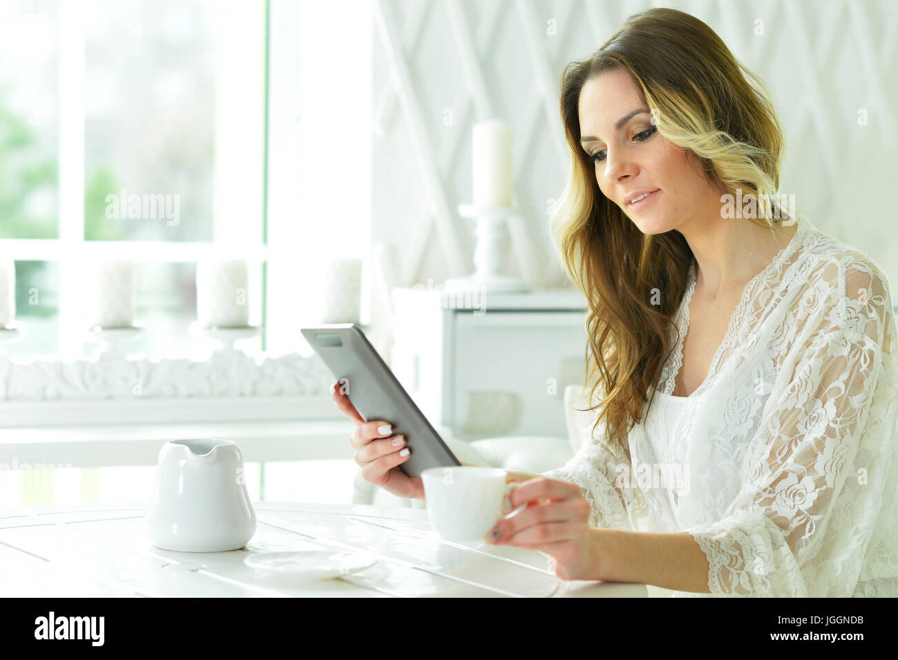 Beautiful woman with tablet in hands Stock Photo - Alamy