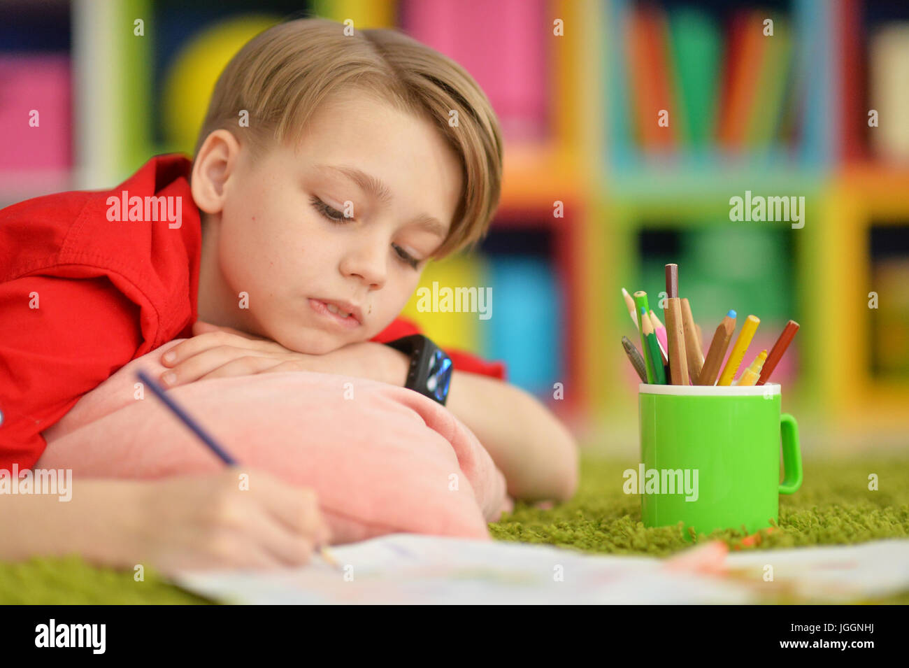 Cute boy drawing with pencils Stock Photo - Alamy