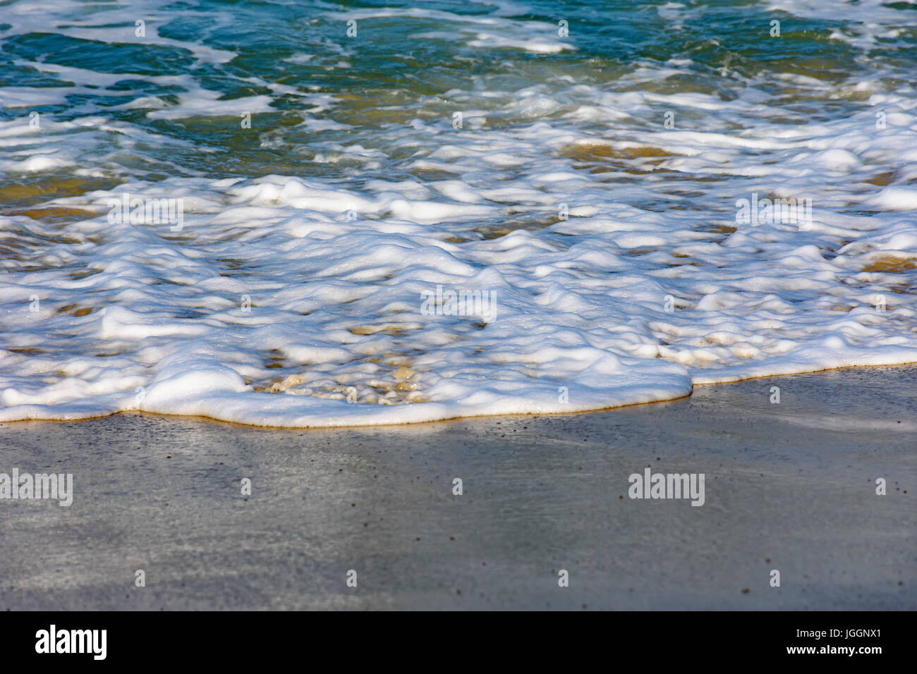 Water over sand in tropical beach Stock Photo - Alamy