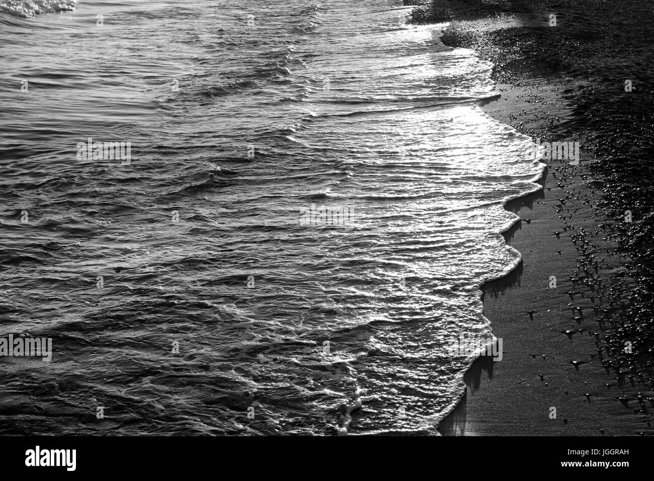 Photo of sea foaming strong waves and sandy shore Stock Photo - Alamy
