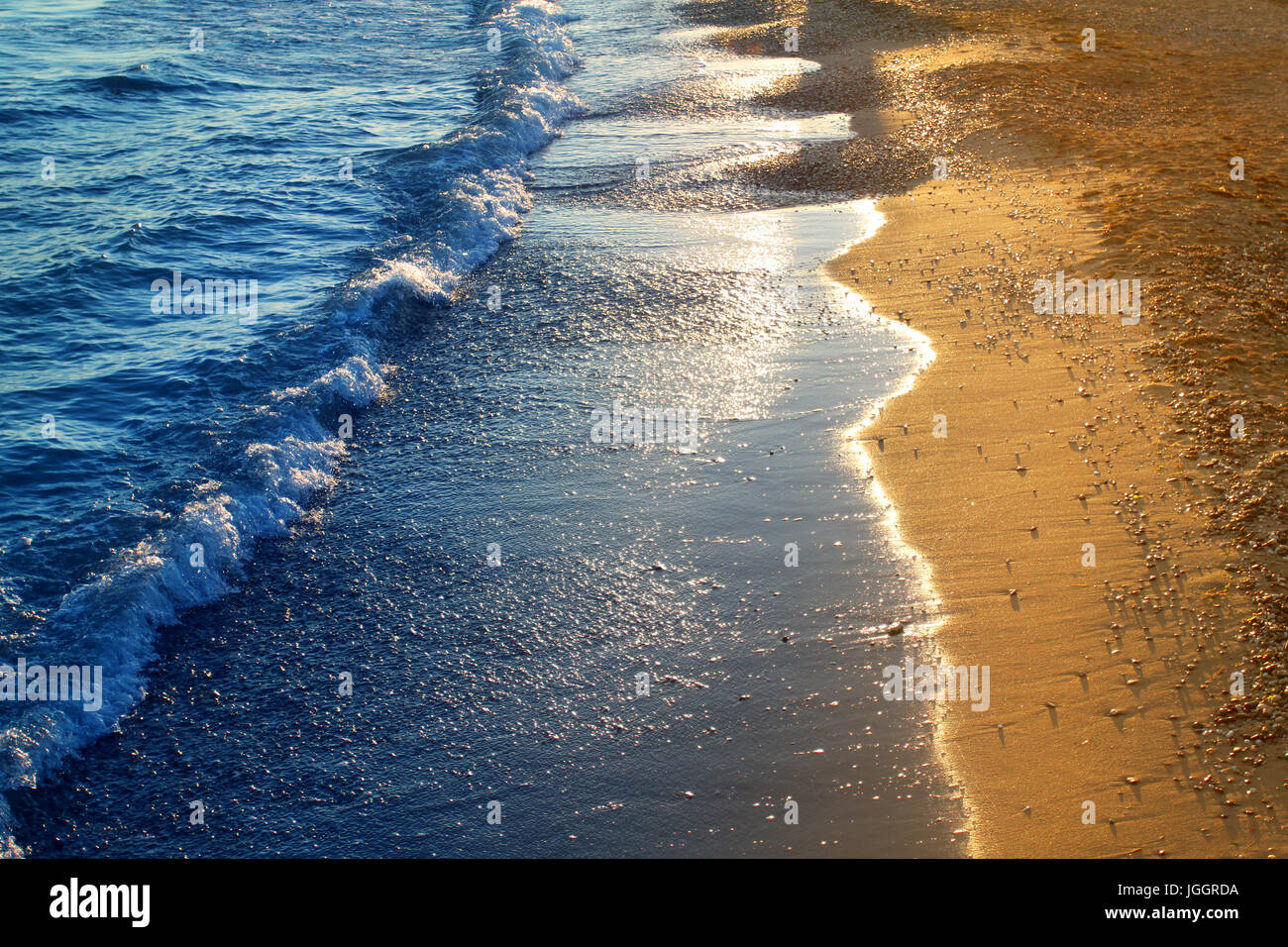 Photo of a background of a bright sunlit wave on the seashore Stock ...