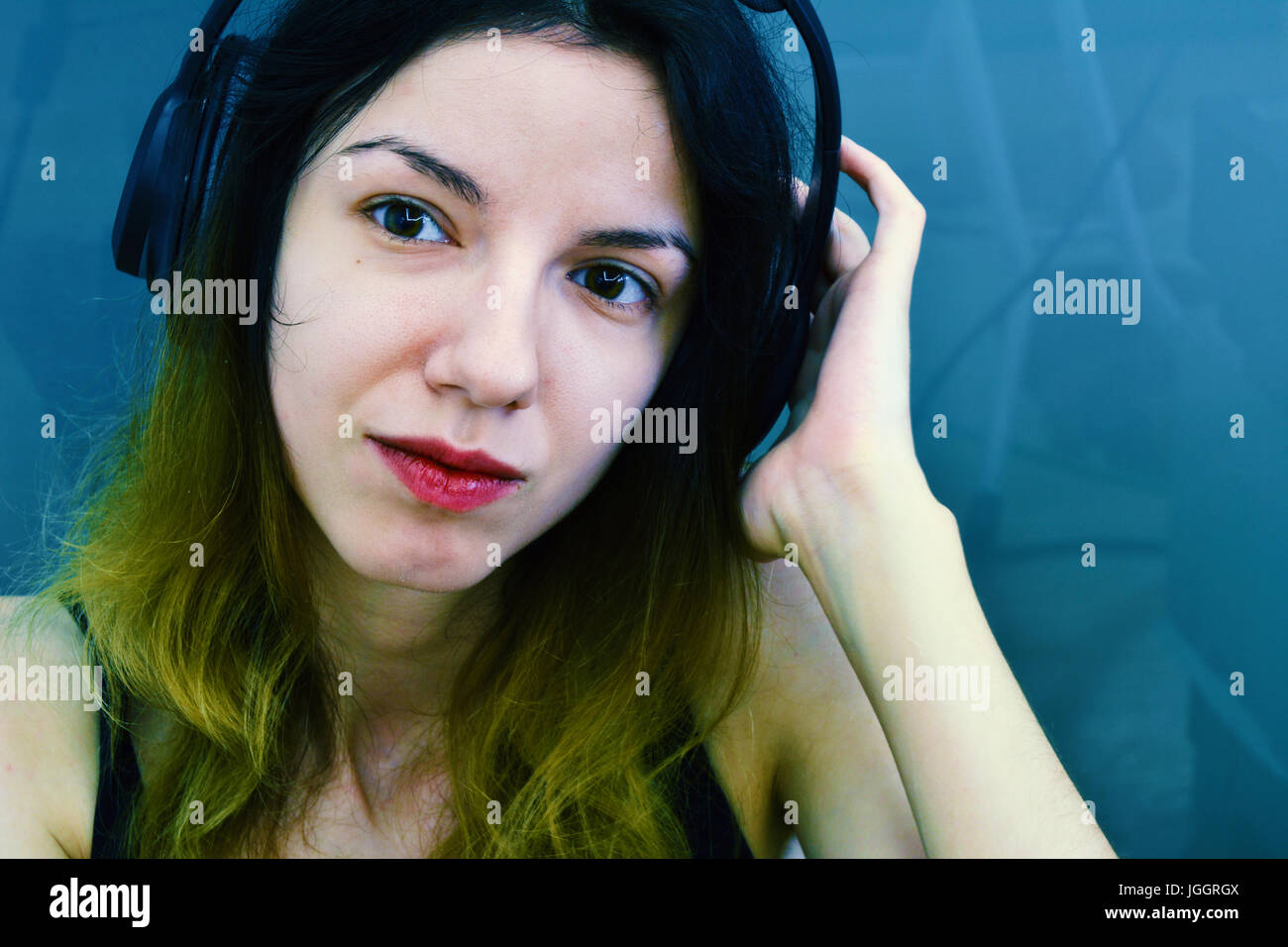 A female model listening and relaxing to music on headphones Stock ...
