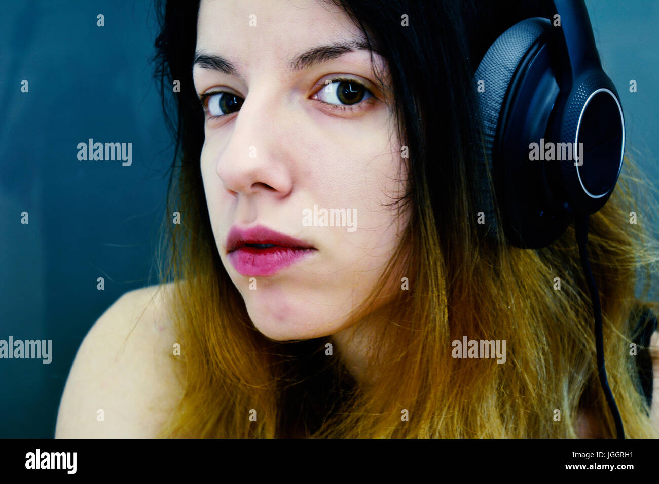 A female model listening and relaxing to music on headphones Stock ...