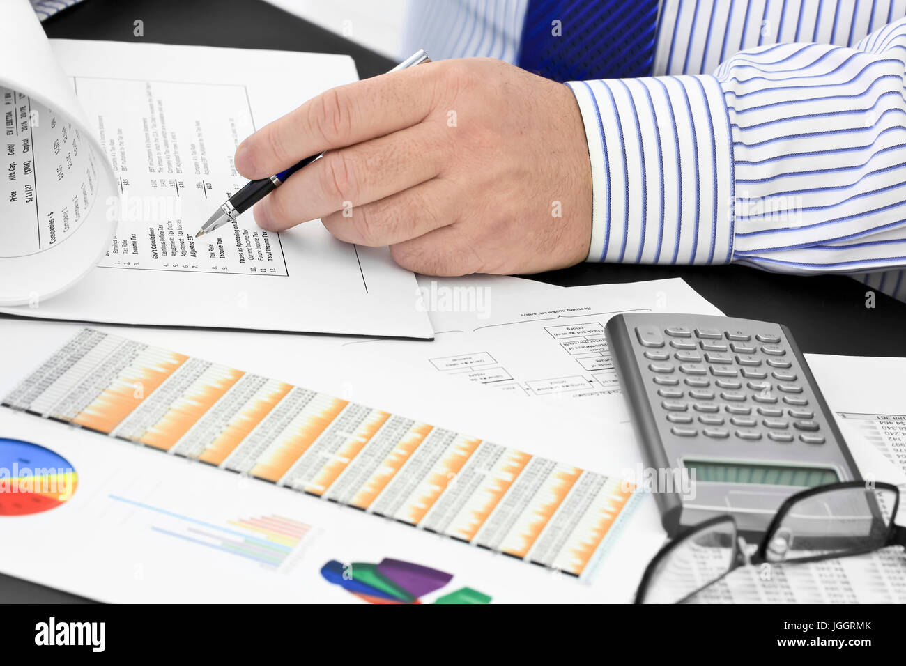 Analyzing financial documents in the office Stock Photo - Alamy