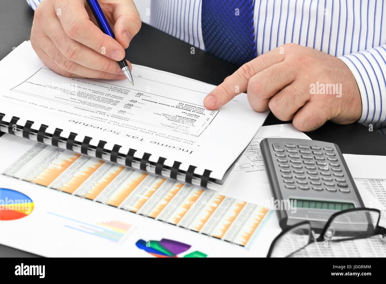 Analyzing financial documents in the office Stock Photo - Alamy