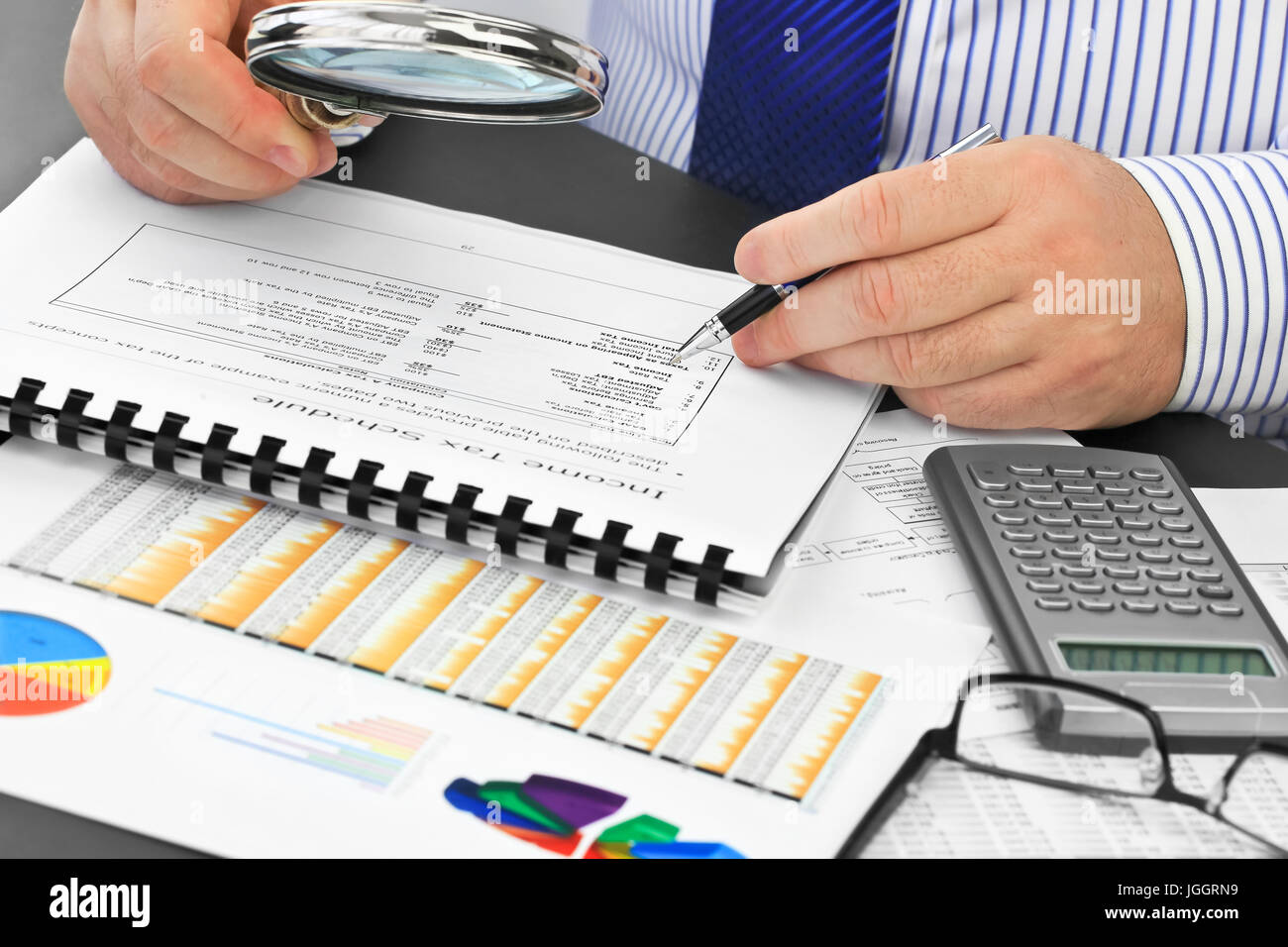 Analyzing financial documents in the office Stock Photo - Alamy