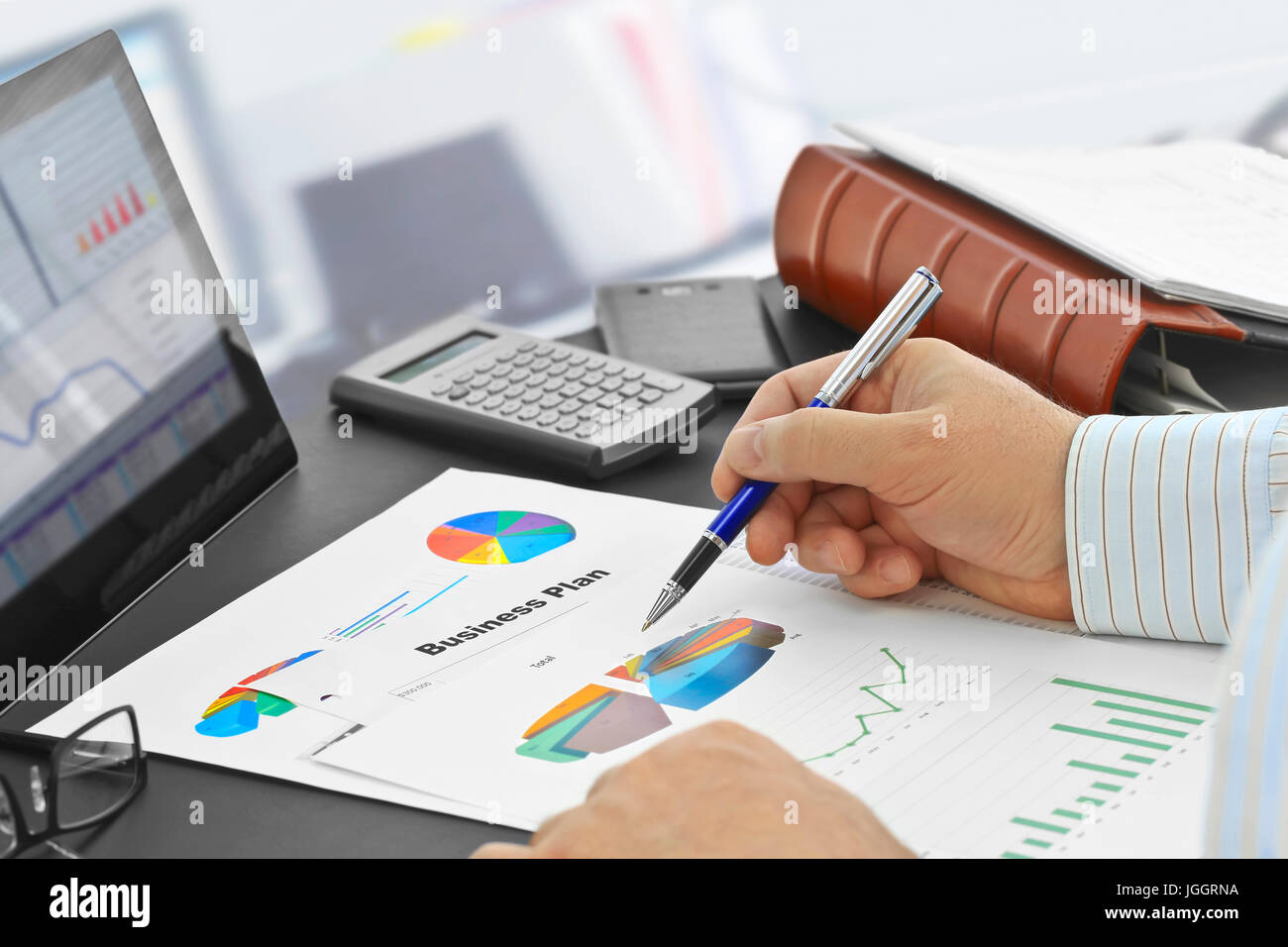 Analyzing financial documents in the office Stock Photo - Alamy