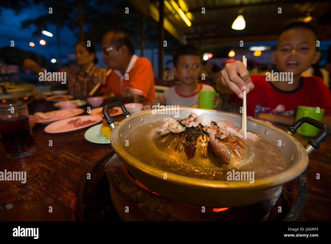 Enjoying a Thai BBQ in a restaurant Stock Photo - Alamy