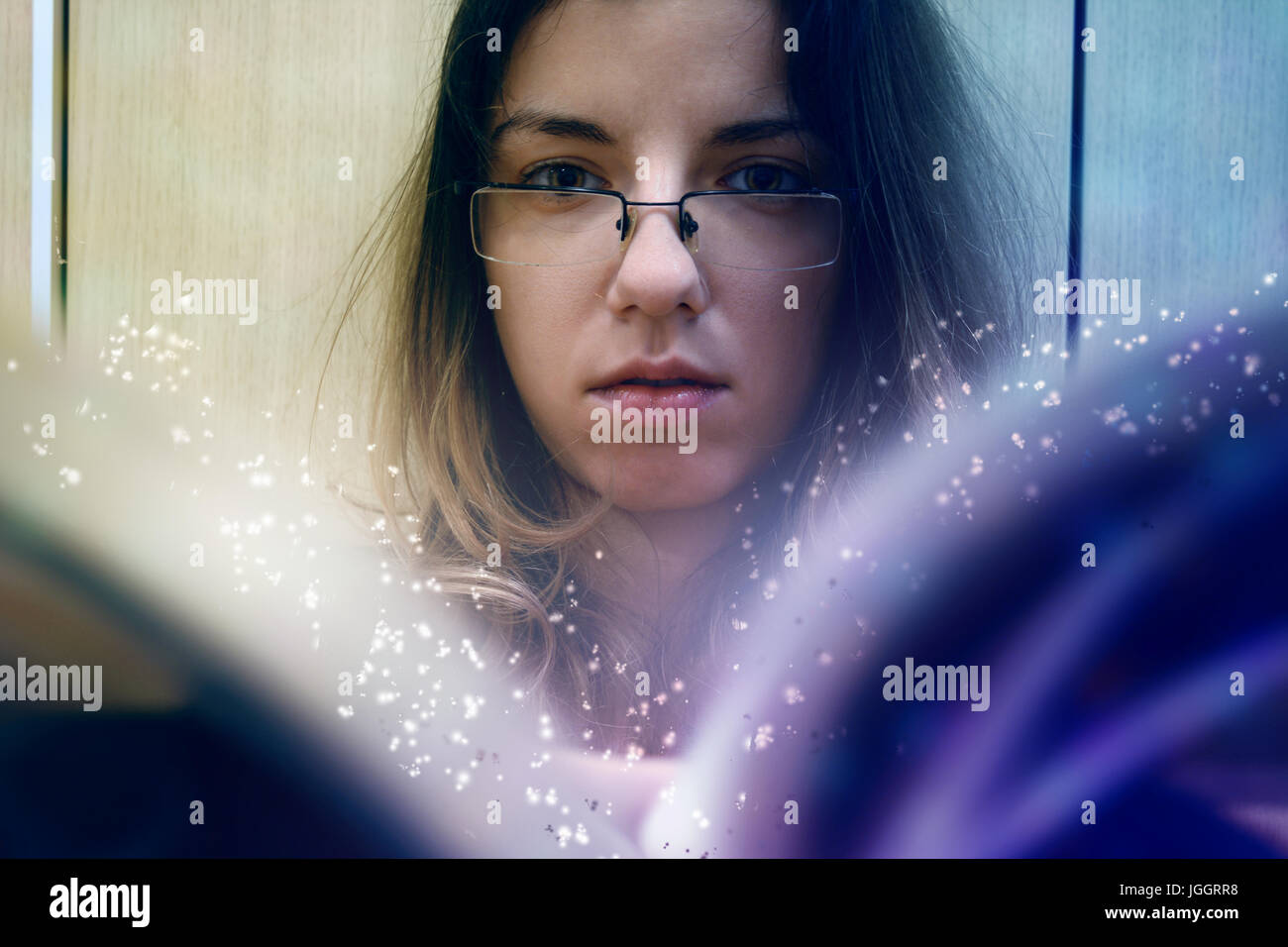 A woman reading a magic book Stock Photo - Alamy