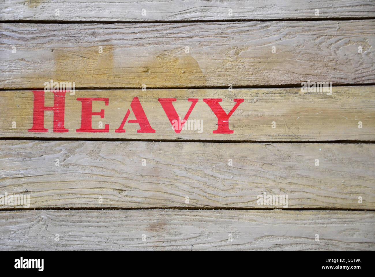 Red heavy word on wooden cardboard box Stock Photo - Alamy