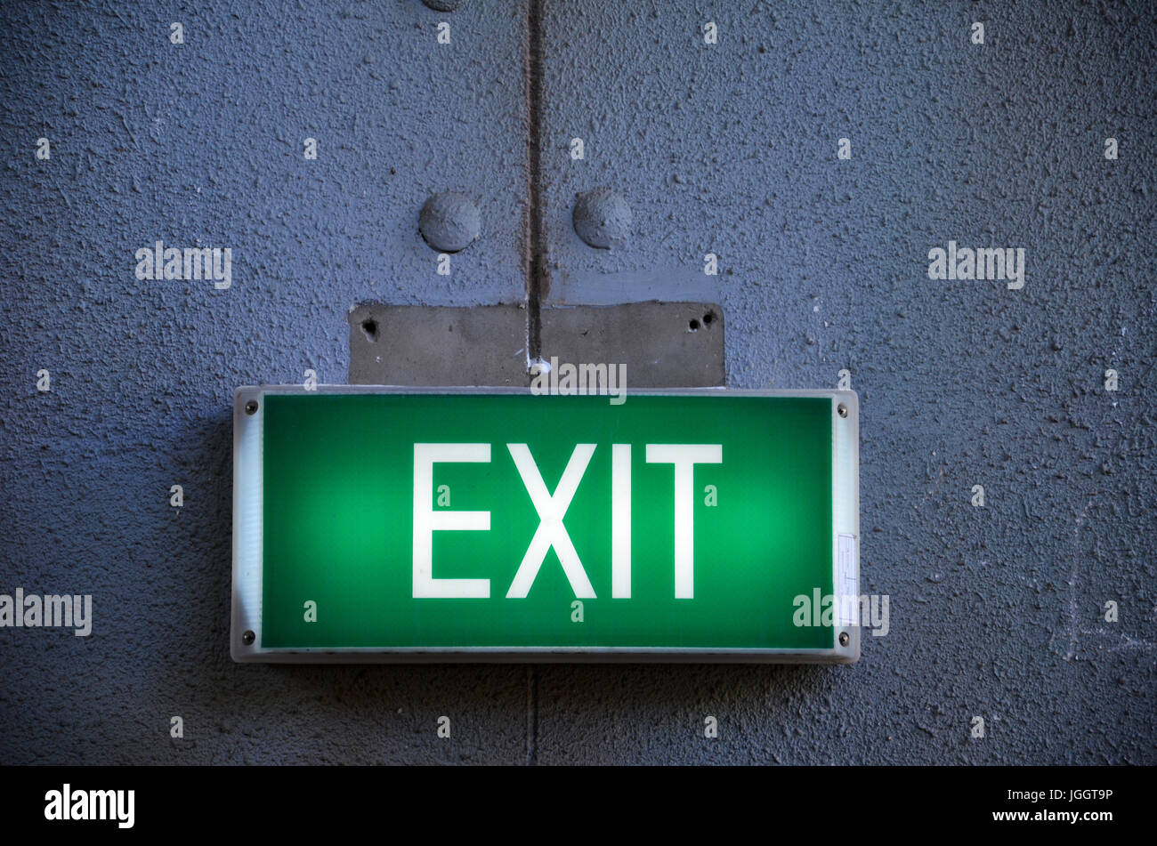 Exit sign points the way out of building Stock Photo - Alamy