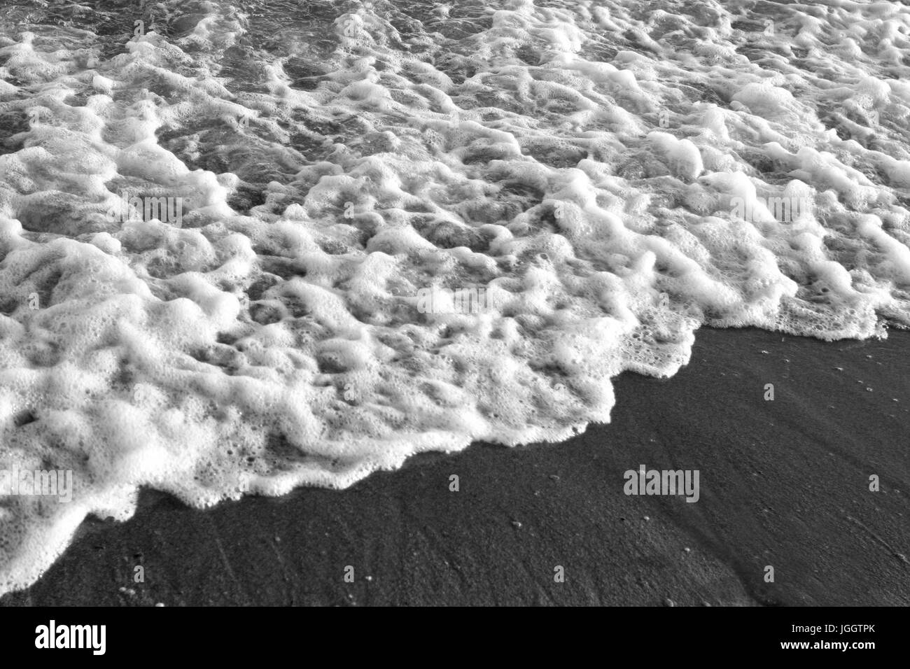 Photo of sea foaming strong waves and sandy shore Stock Photo - Alamy
