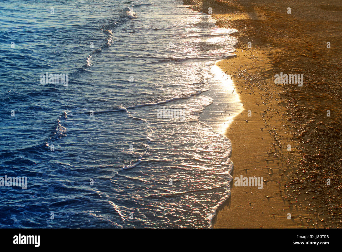 Photo of a background of a bright sunlit wave on the seashore Stock ...