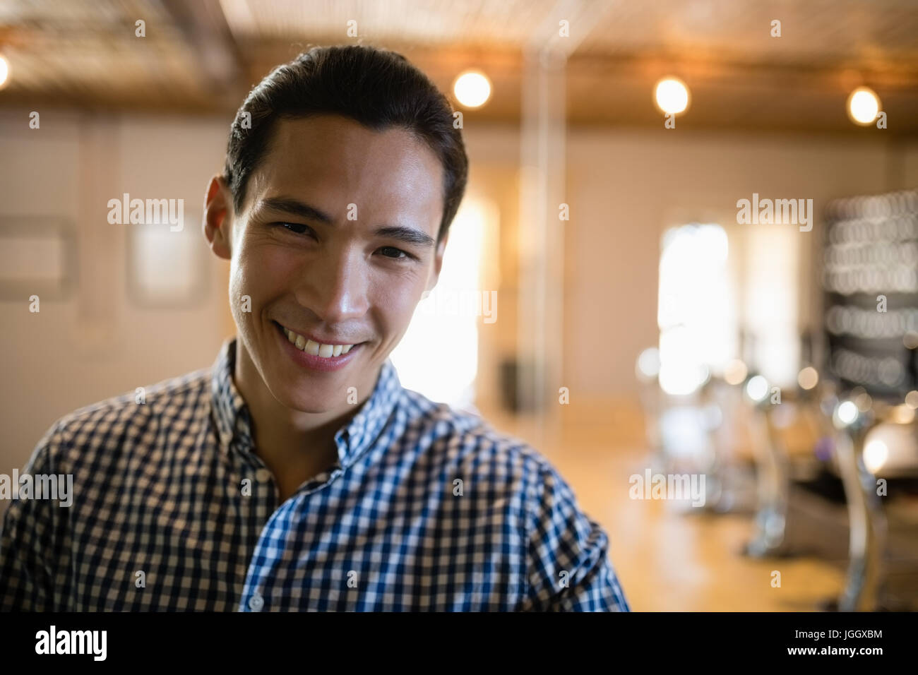 Portrait of smiling man at counter in restaurant Stock Photo - Alamy