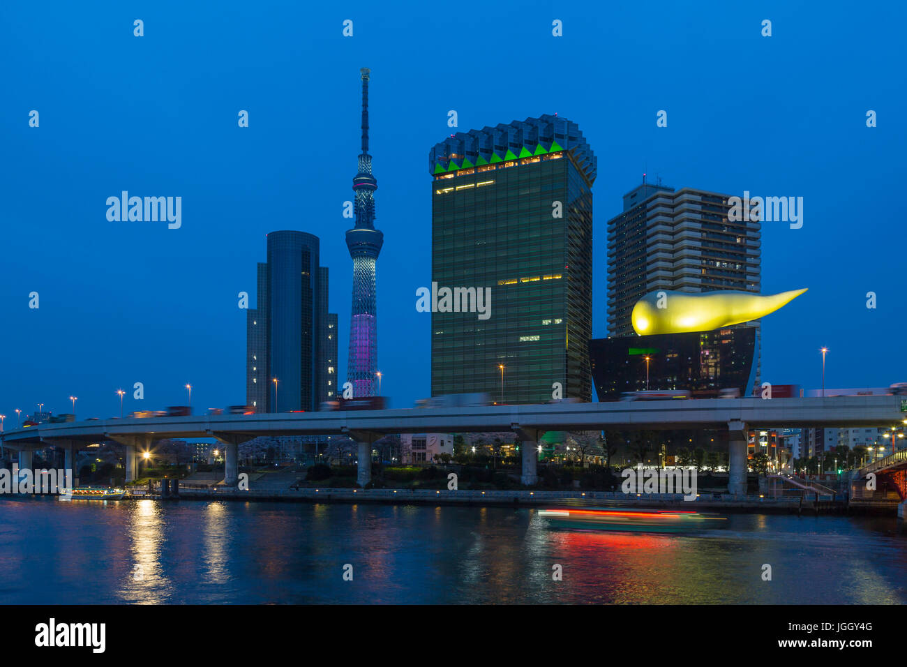 High rise office buildings and the Tokyo Skytree tower illuminated at ...