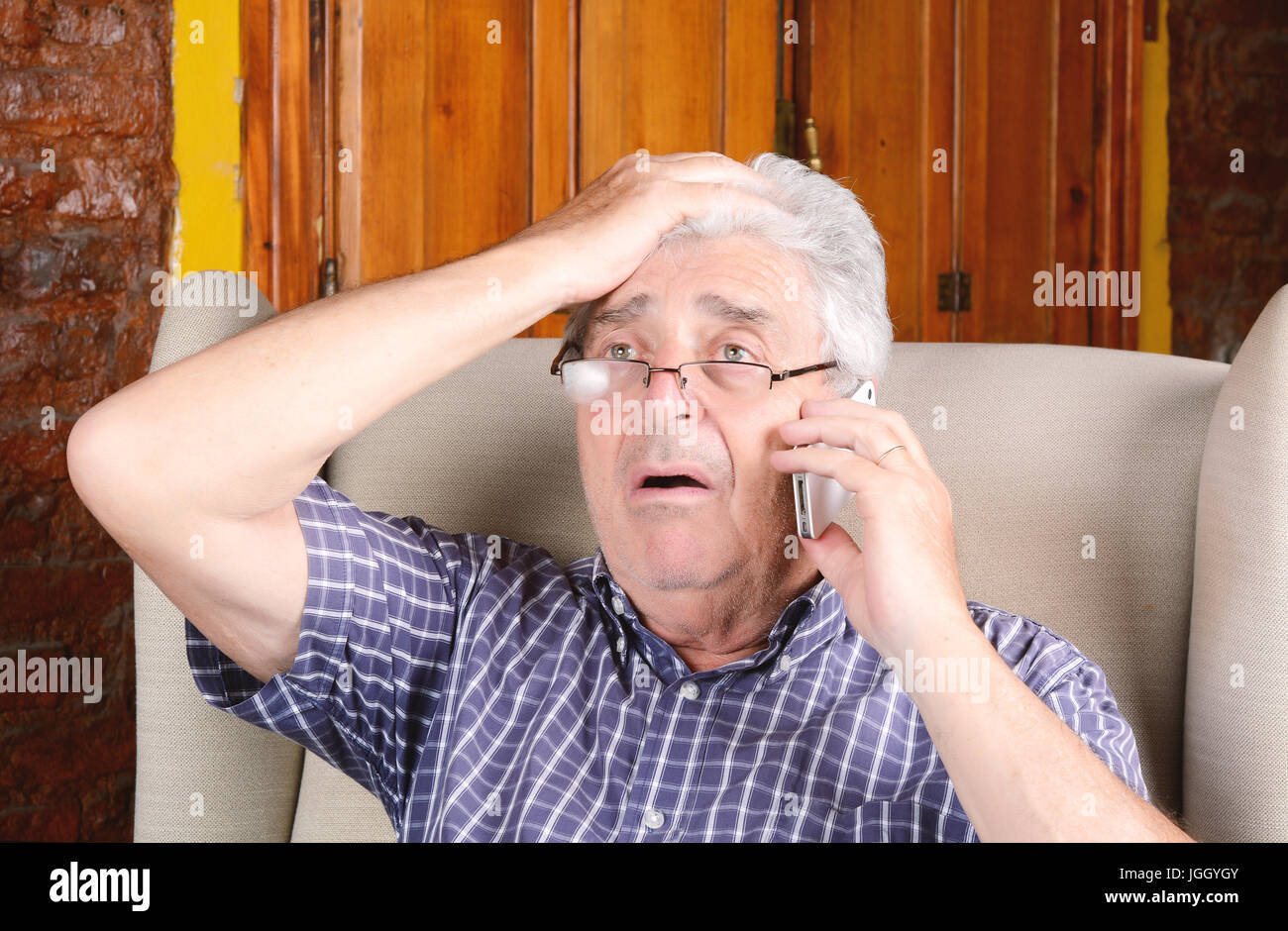Portrait of an old man talking on the phone. Indoors Stock Photo - Alamy
