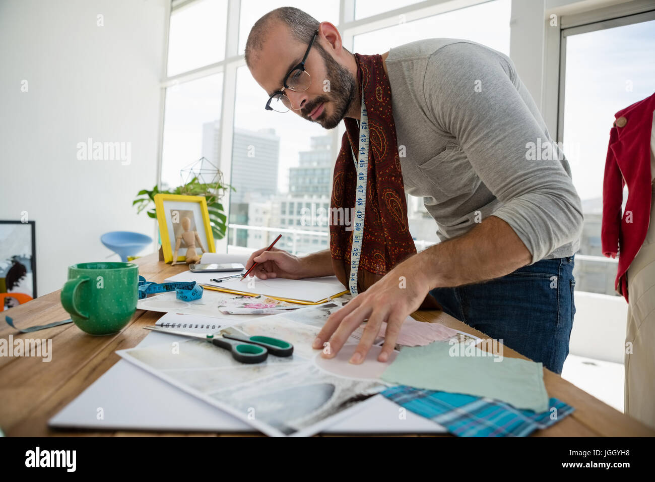 Male designer drawing sketch while standing in workshop Stock Photo - Alamy