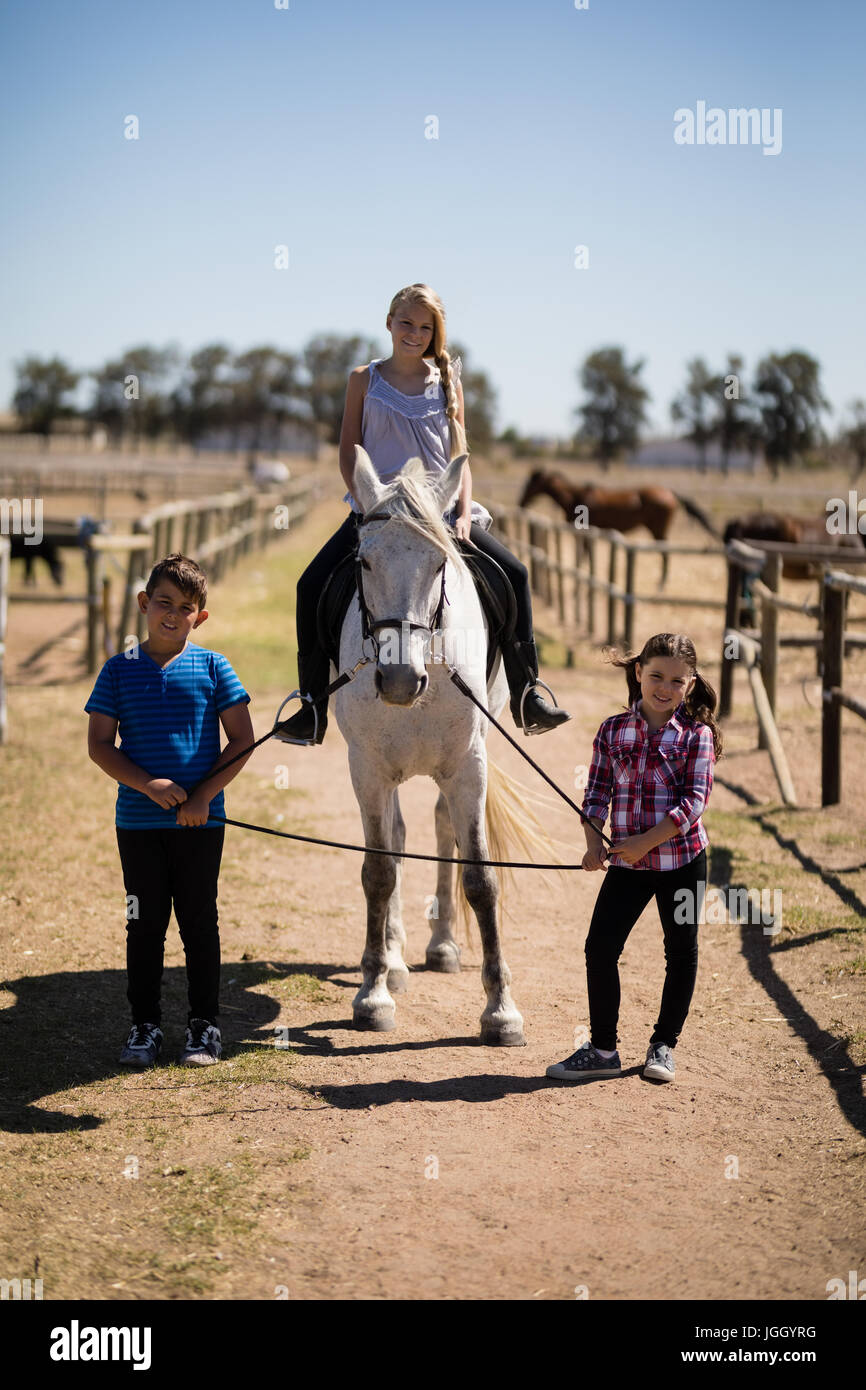 Kids riding a horse in the ranch on a sunny day Stock Photo - Alamy