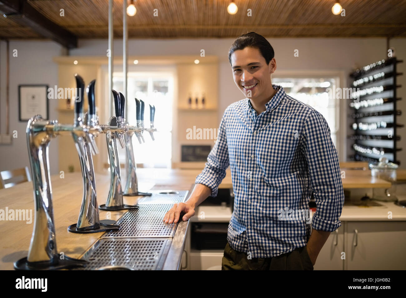 Portrait of smiling man at counter in restaurant Stock Photo - Alamy