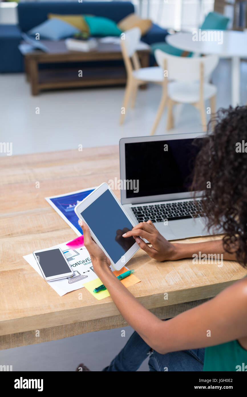 Female executive using digital tablet at desk in the office Stock Photo ...