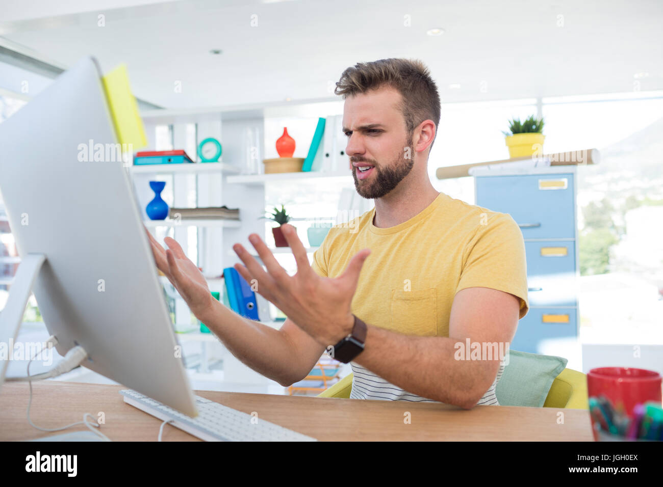 Depressed male executive working on computer in the office Stock Photo ...