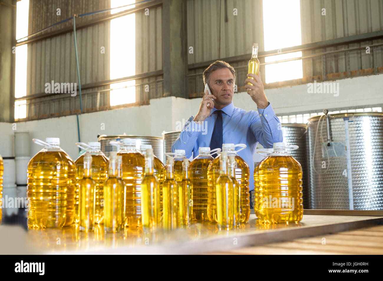 Senior man holding oil container hi-res stock photography and images ...