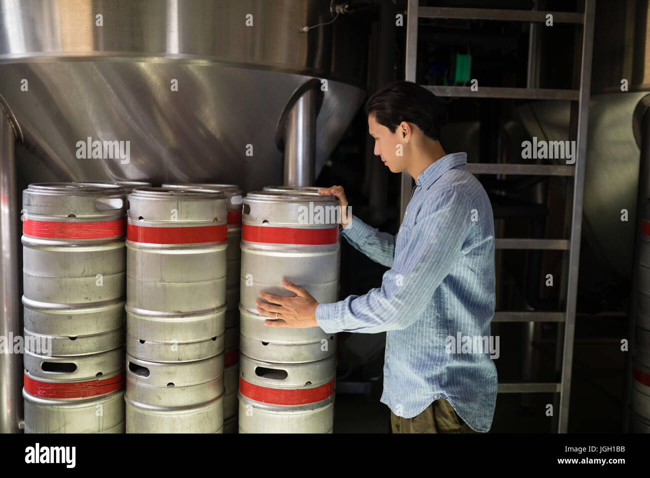 Manager checking beer keg in warehouse of restaurant Stock Photo - Alamy