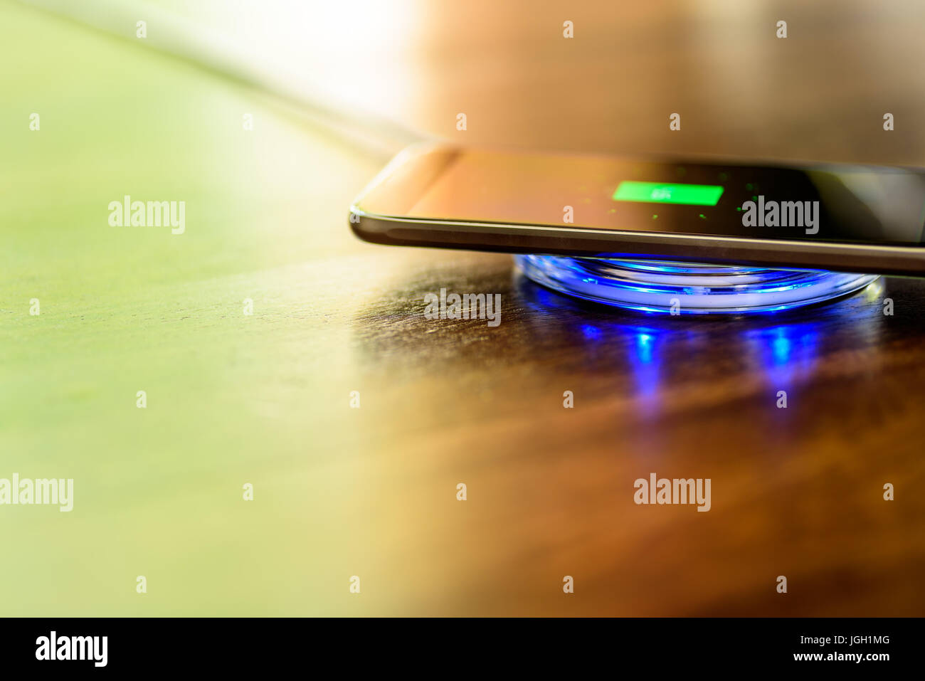 Smartphone charging on a charging pad. Wireless charging Stock Photo ...