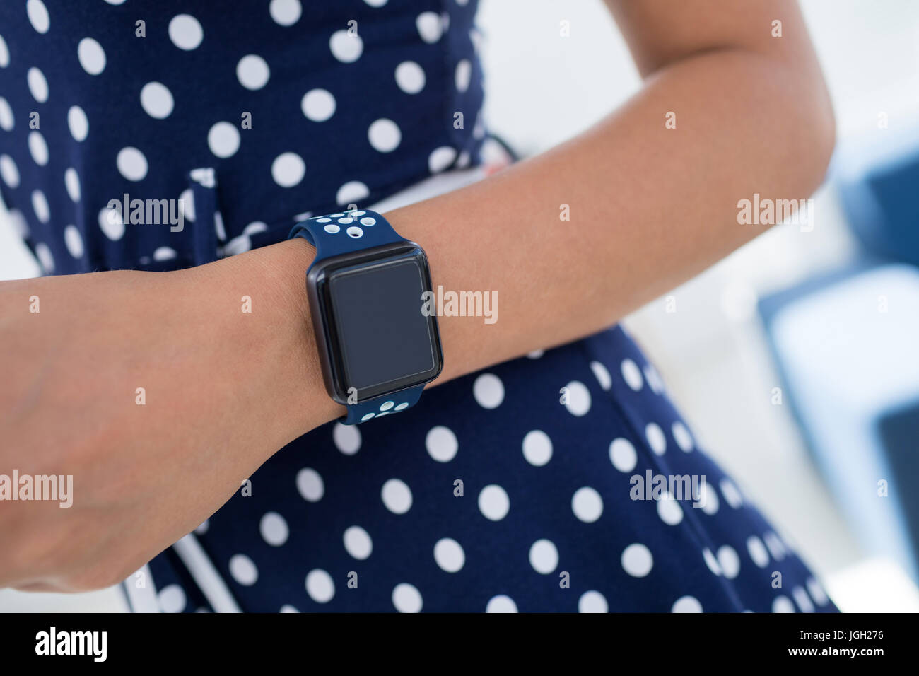 Mid-section of female executive wearing smartwatch in the office Stock ...