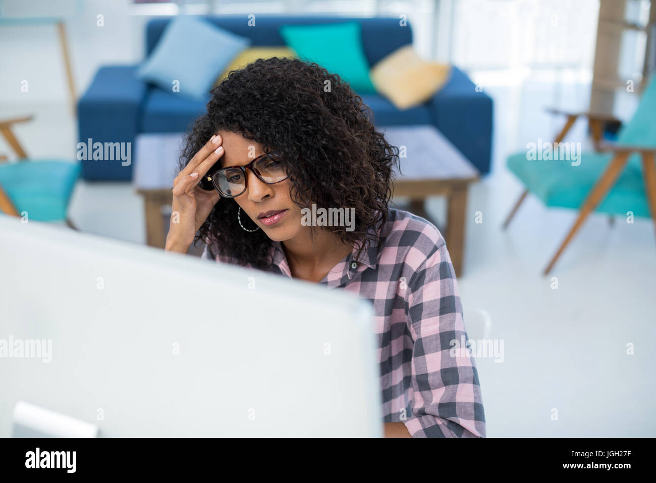 Female executive suffering from headache at desk in the office Stock ...