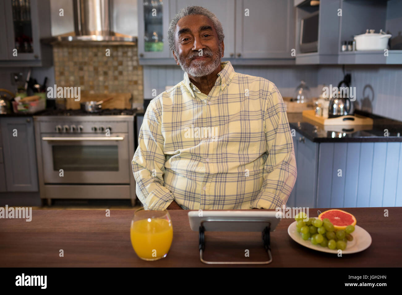 Portrait of smiling senior man in kitchen at home Stock Photo - Alamy