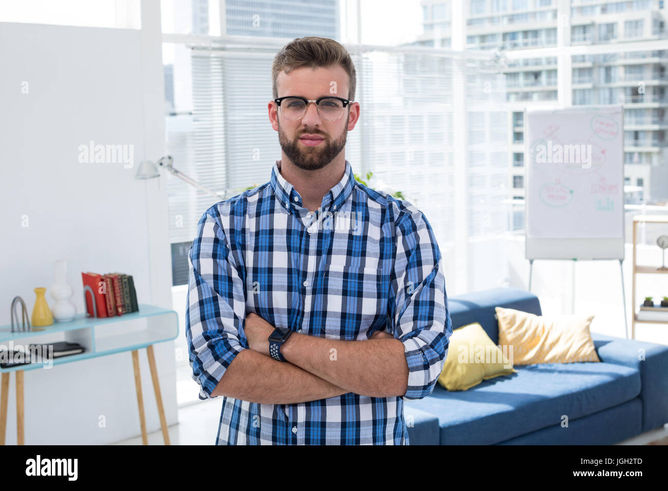 Portrait of male executive standing with arms crossed in office Stock ...