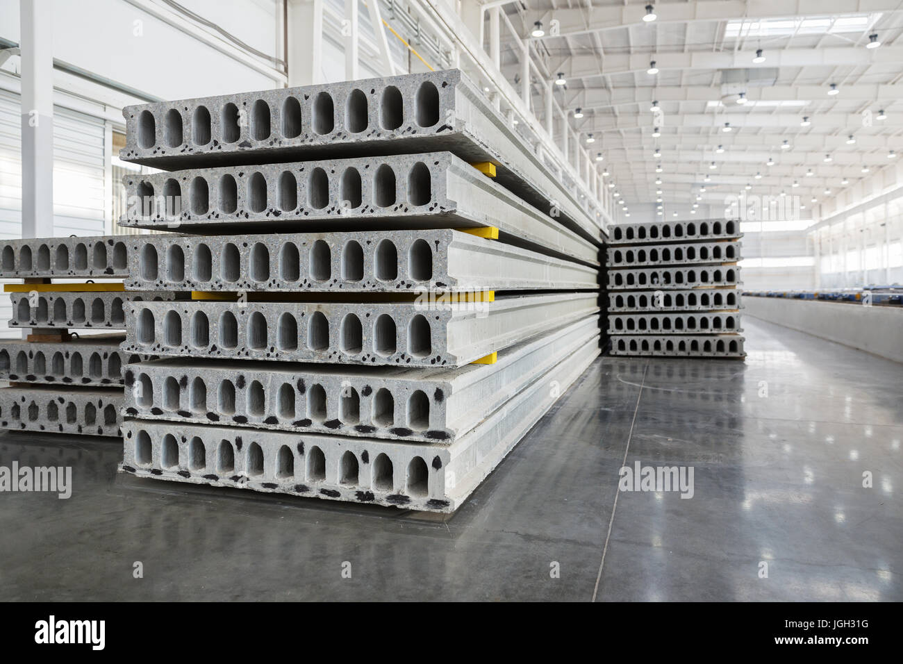 Stack of precast reinforced concrete slabs in a house-building factory ...