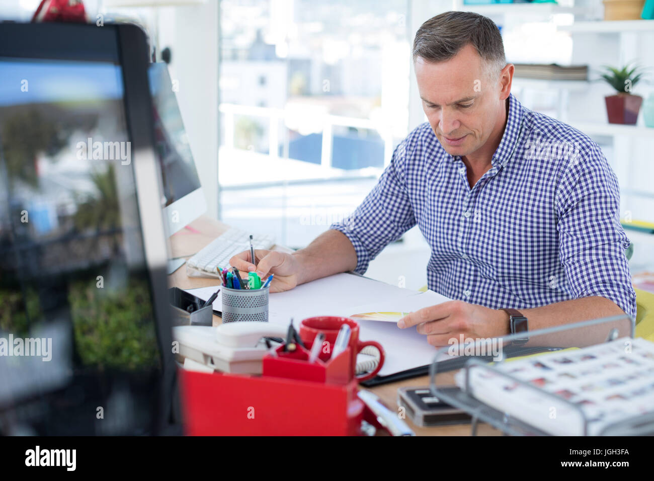 Male executive working at desk in the office Stock Photo - Alamy