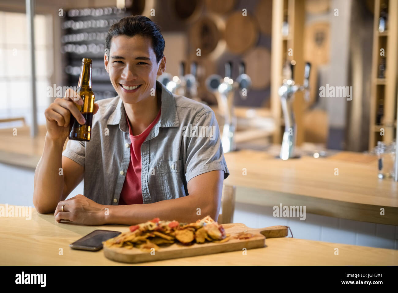 Portrait of man having beer in a restaurant Stock Photo - Alamy