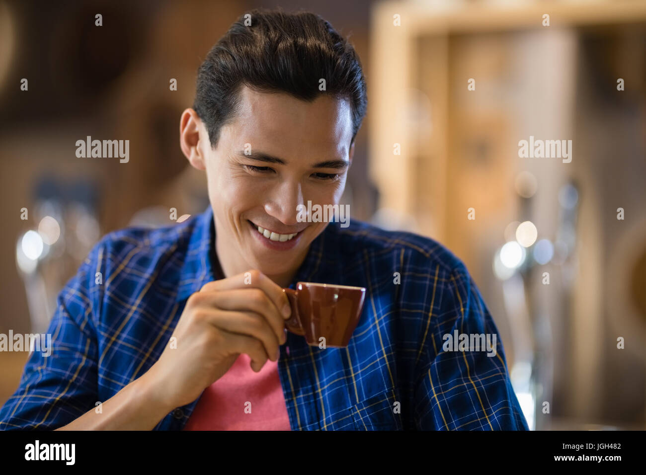 Smiling man having coffee in restaurant Stock Photo - Alamy