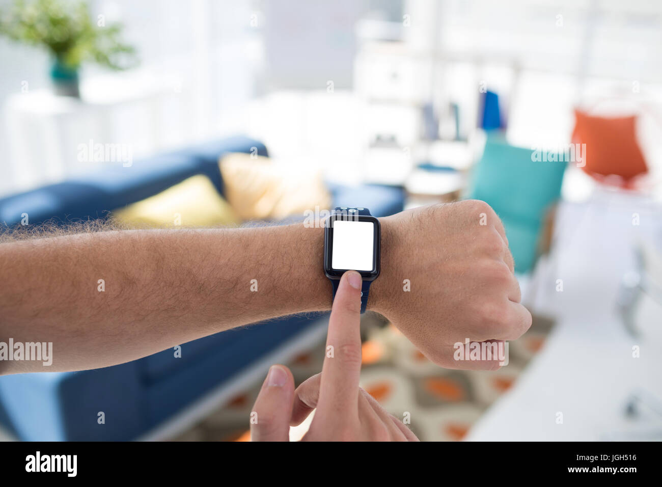 Male executive using smartwatch in the office Stock Photo - Alamy