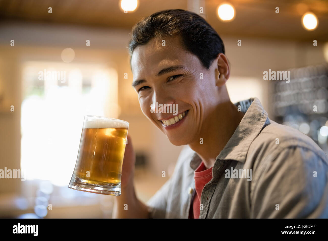 Portrait of man having beer in a restaurant Stock Photo - Alamy