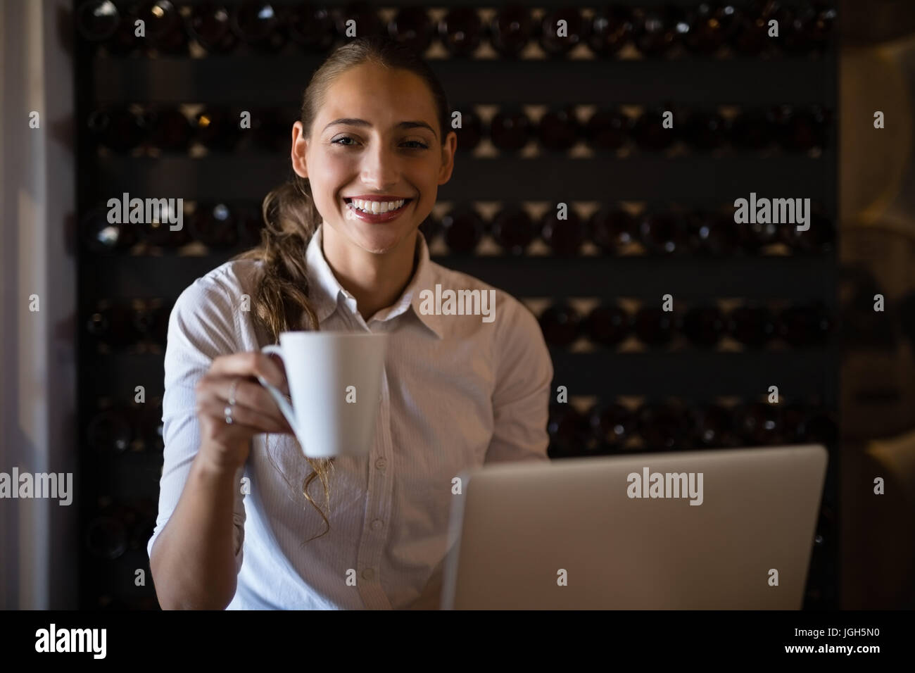 Portrait of smiling woman having coffee in cafe Stock Photo - Alamy