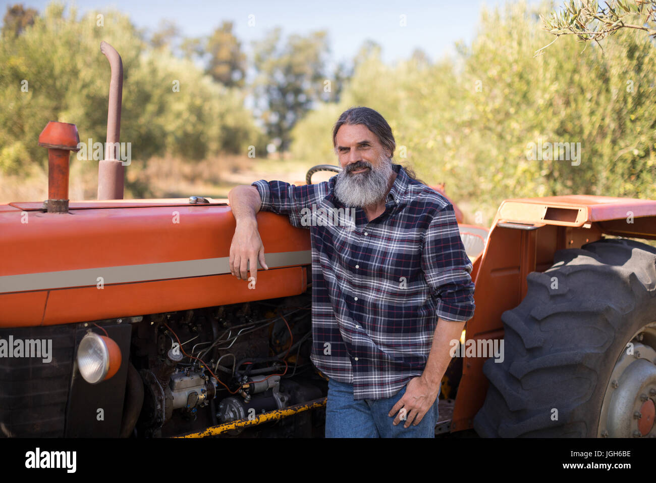 Portrait farmer leaning tractor field hi-res stock photography and ...